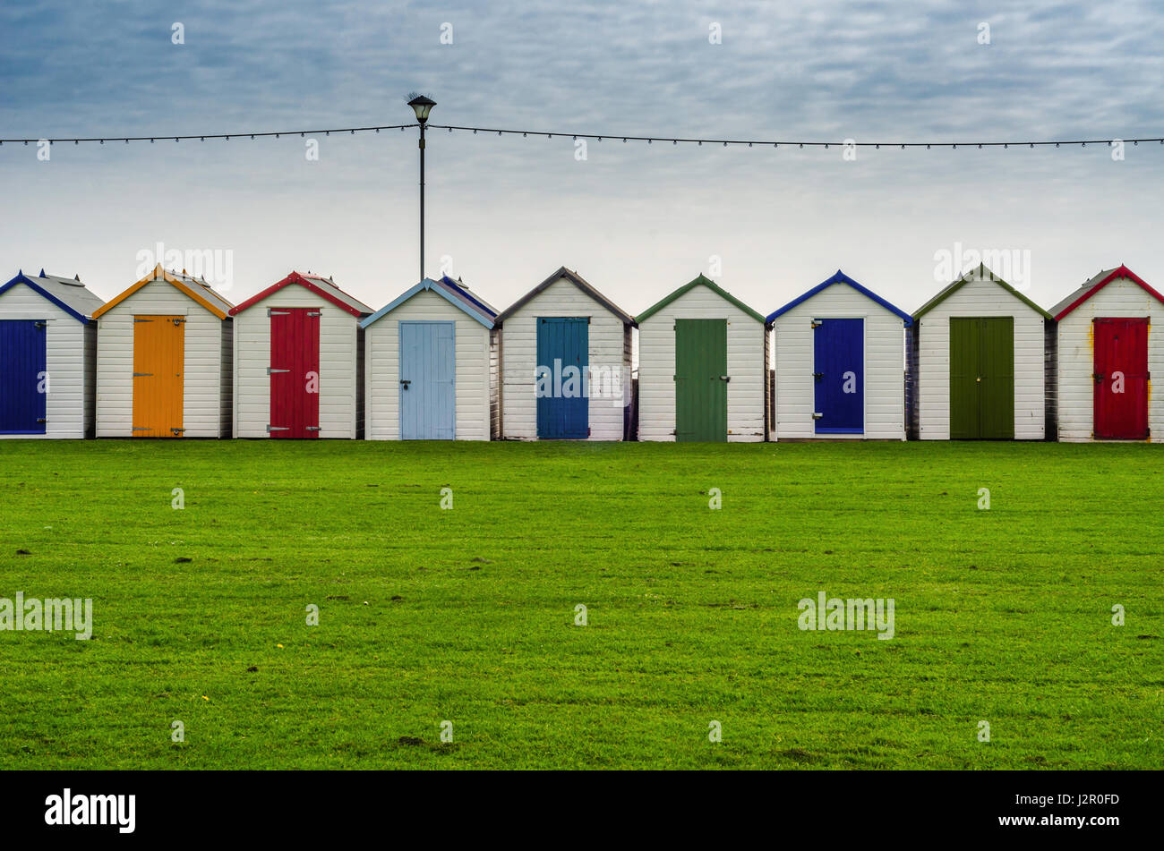 Colored houses on the beach, colorful door to summer cottages, seaside ...