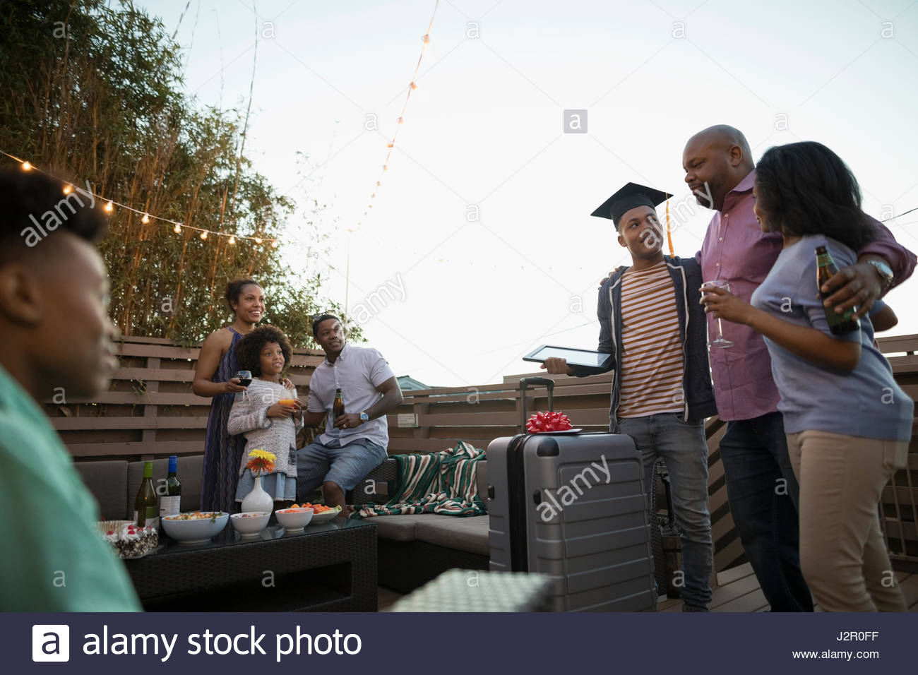 African American family celebrating graduation on summer deck Stock ...