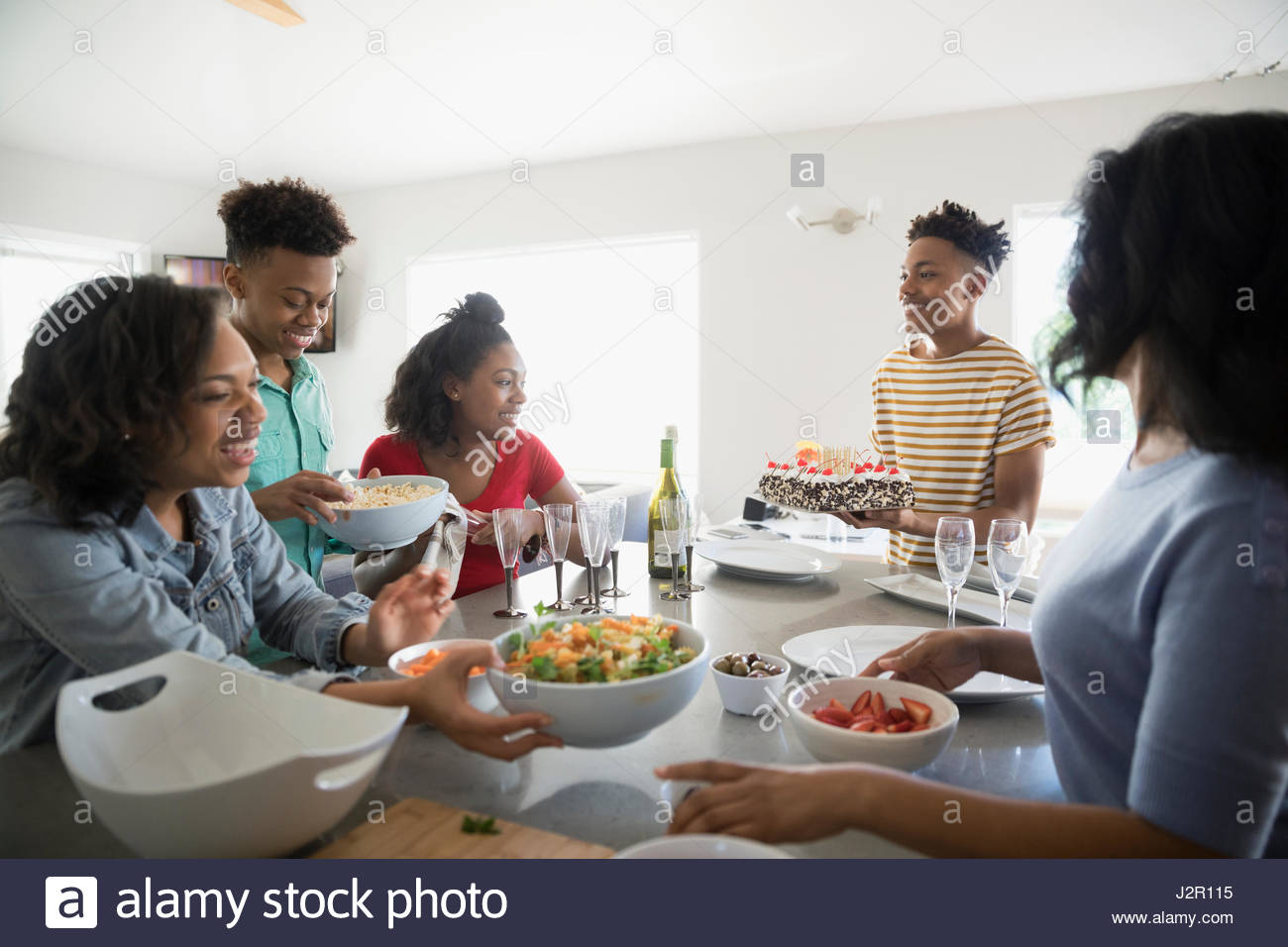 African American family cooking and eating in kitchen Stock Photo - Alamy