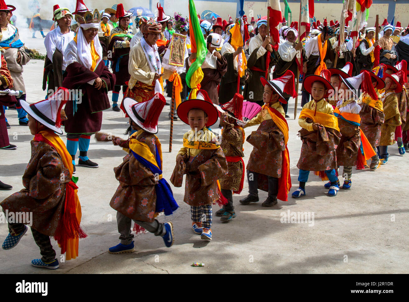 A line of young boys dancing during a Tibetan ritual ceremony in a ...