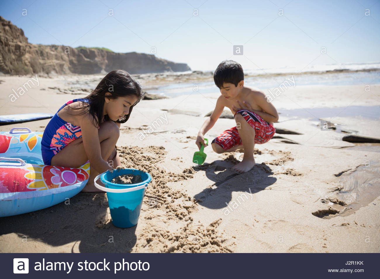 Two girls playing in sand hi-res stock photography and images - Alamy