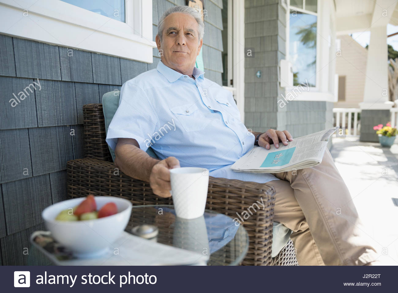 Man reading newspaper on porch hi-res stock photography and images - Alamy