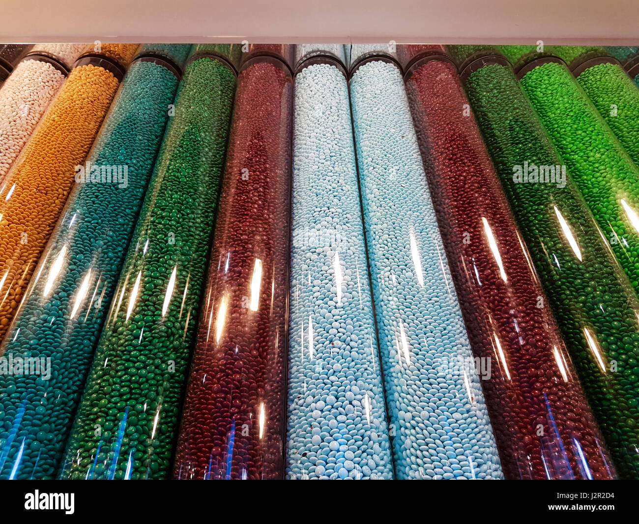 Eleven visible rows of sweets organised by colour Stock Photo - Alamy