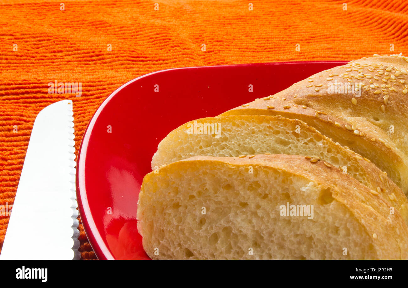 sliced whole wheat breads with a knife on a red plate Stock Photo - Alamy