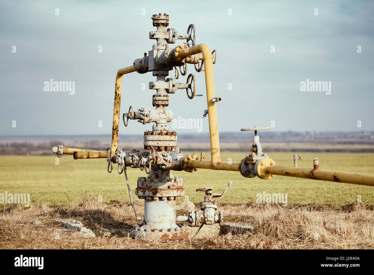 Old gas pipeline in the middle of the field. Extraction of gas from ...