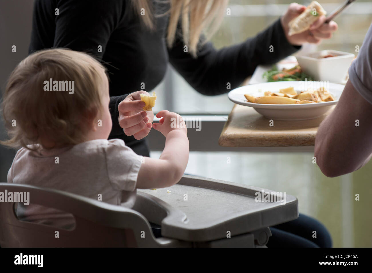 Restaurant Toddler Parent Parent feeding her child Eating Hungry Stock ...