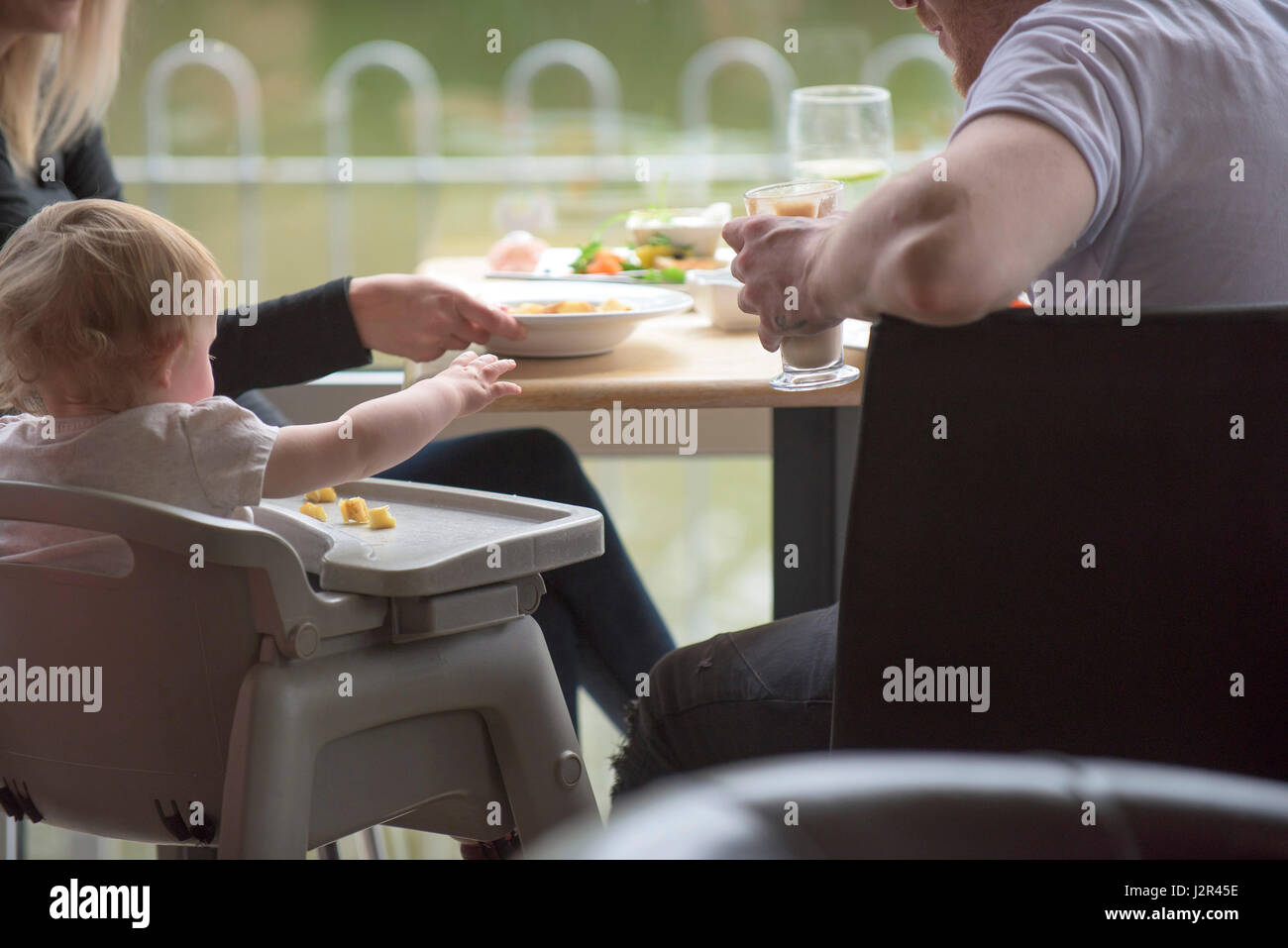 Restaurant Interior Parents and a child Customers Eating Food Toddler ...