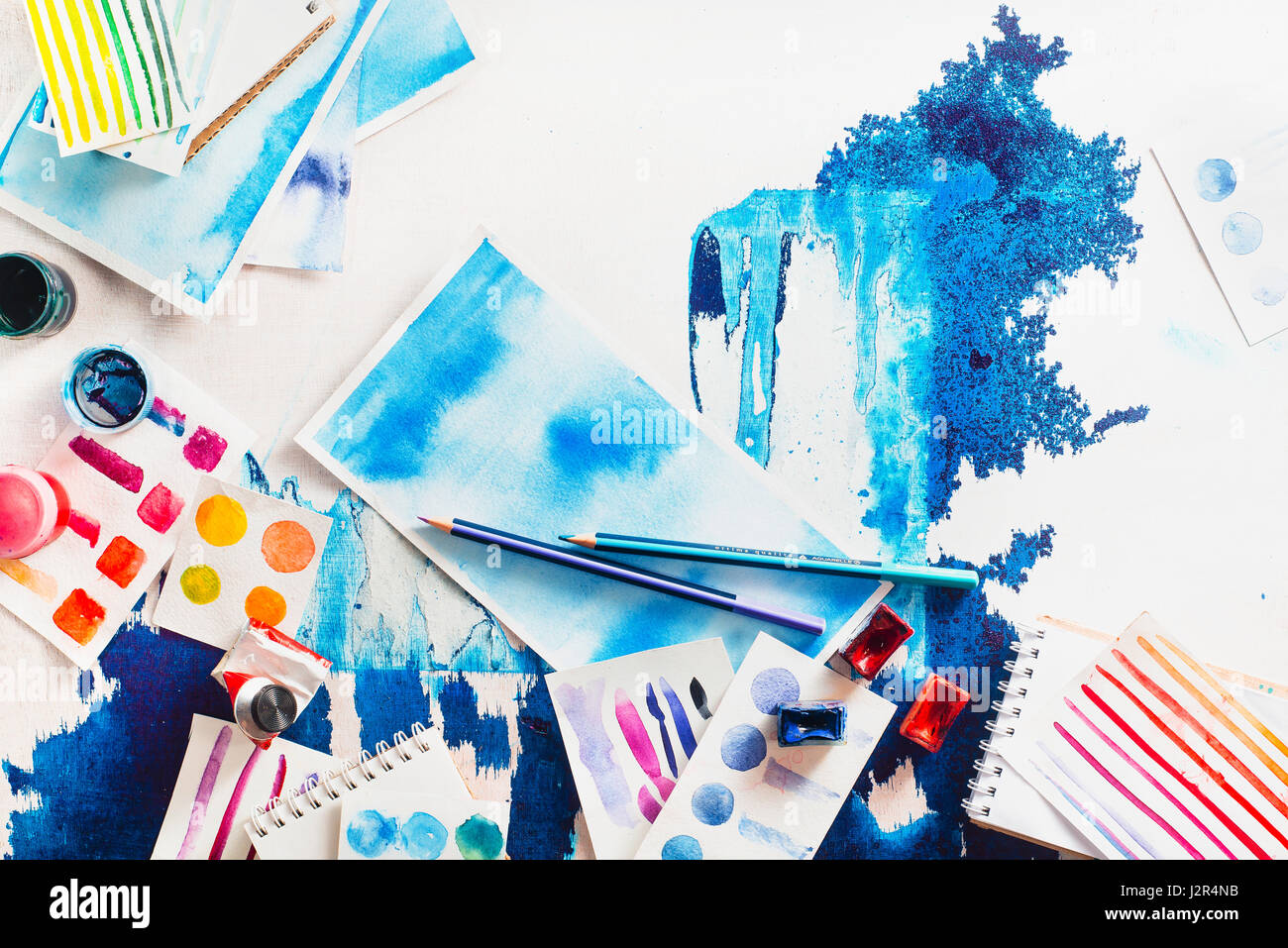 Creative artist workplace with watercolor and sketches Stock Photo - Alamy