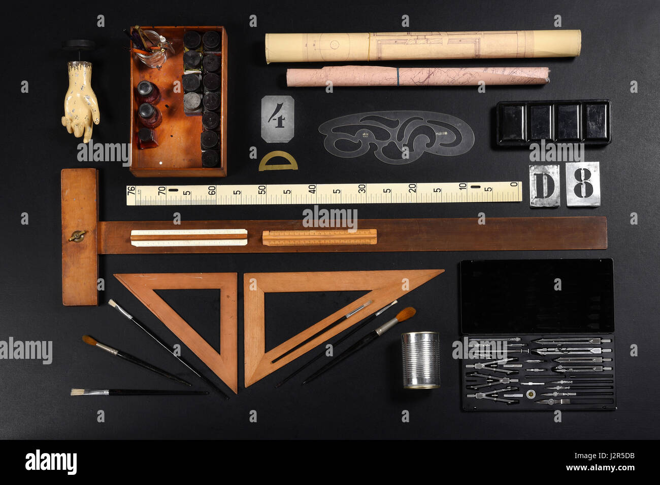 Set of drawing or draughtsman tools neatly arranged on grey with a ...