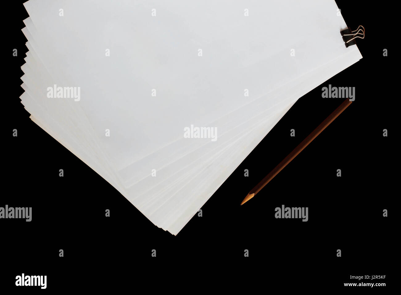 White paper and pencil on a black background Stock Photo - Alamy