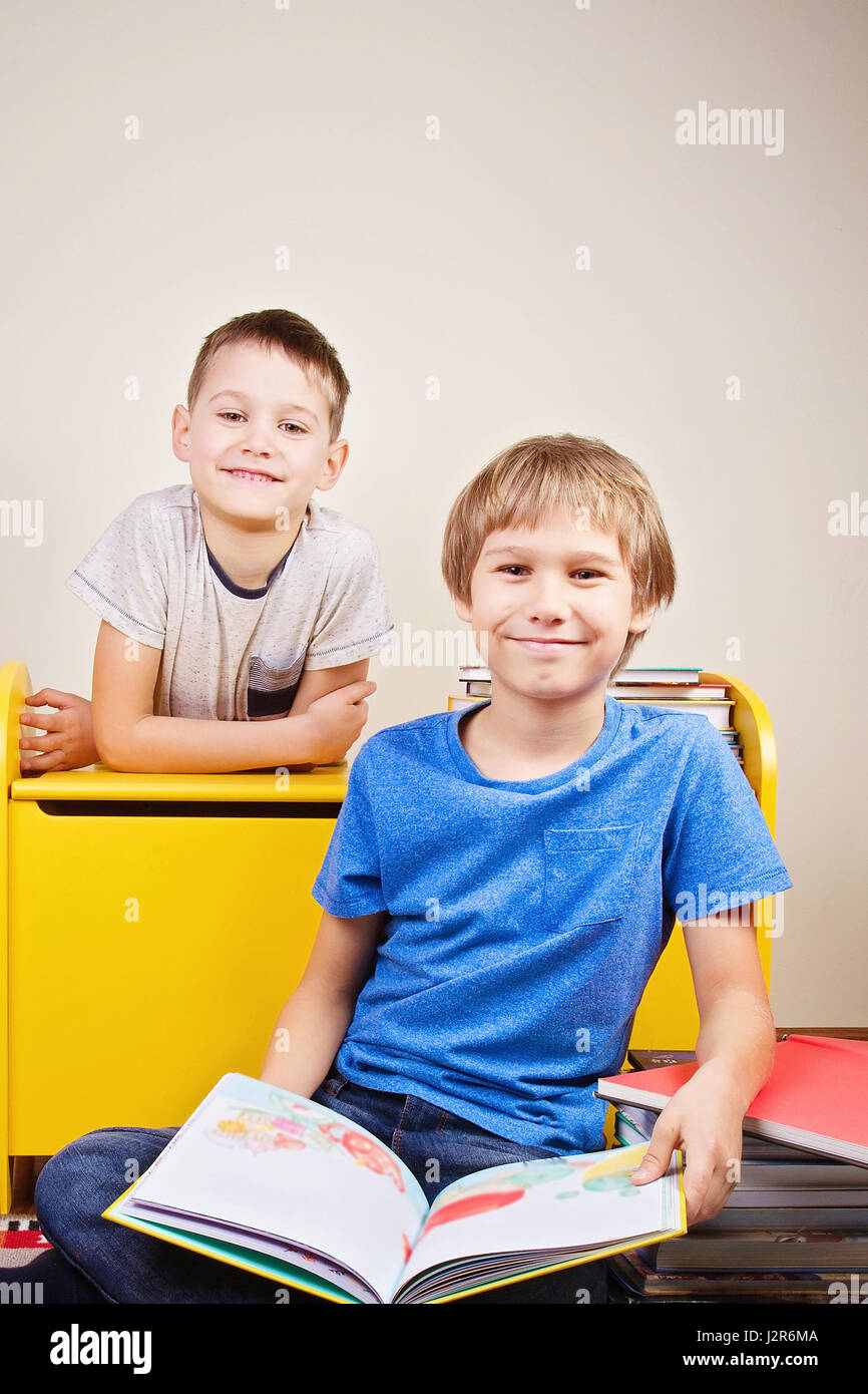 Kids reading books at home Stock Photo - Alamy