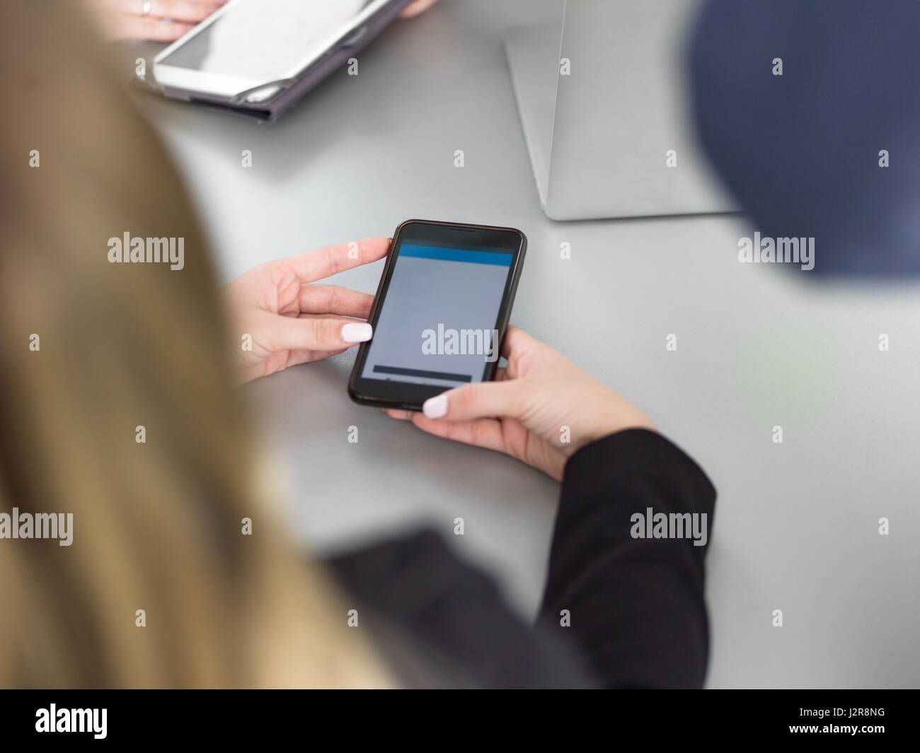 female manager using cell telephone in office interior Stock Photo - Alamy