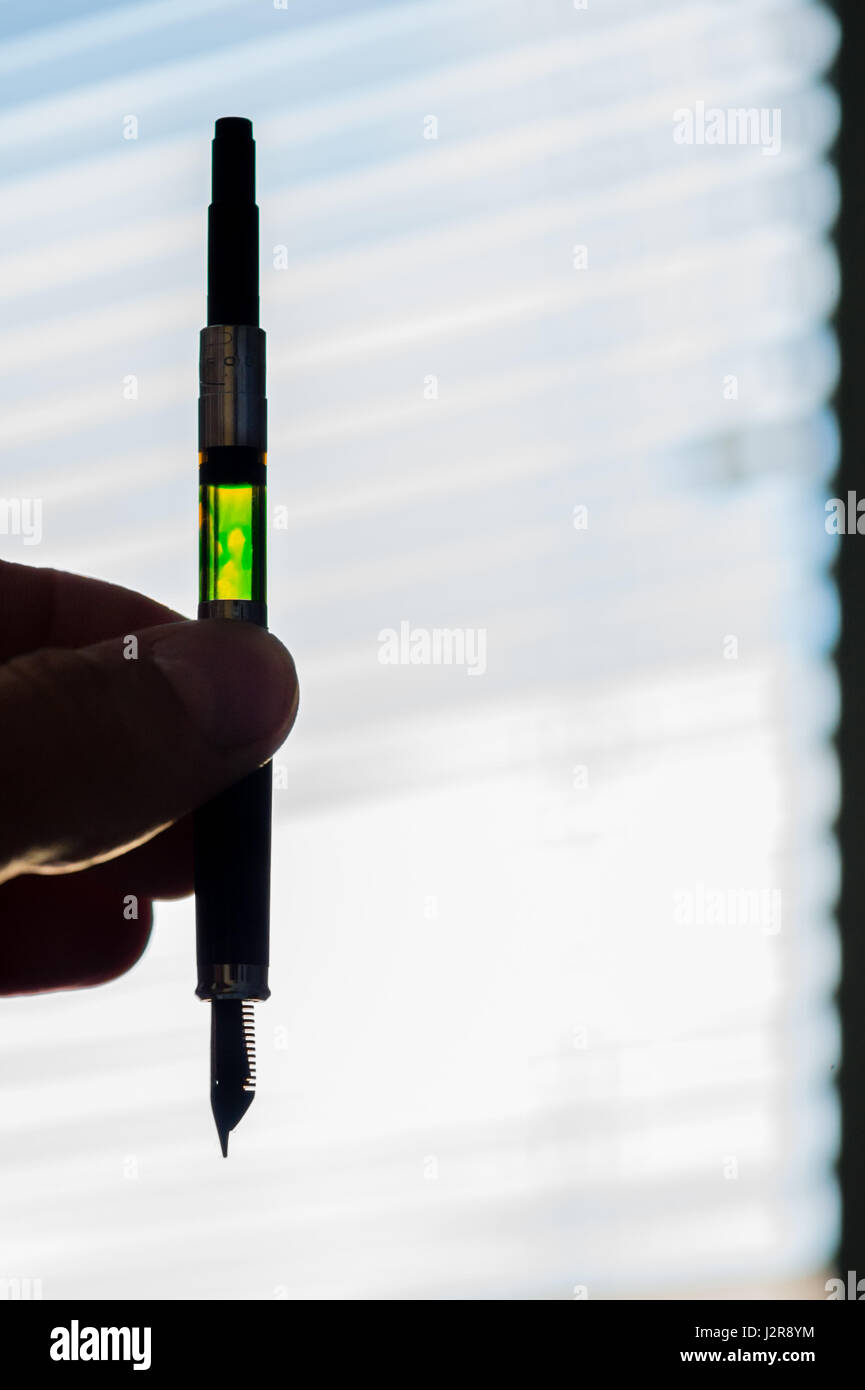 Fountain Pen and hand displaying empty ink chamber whilst working from ...