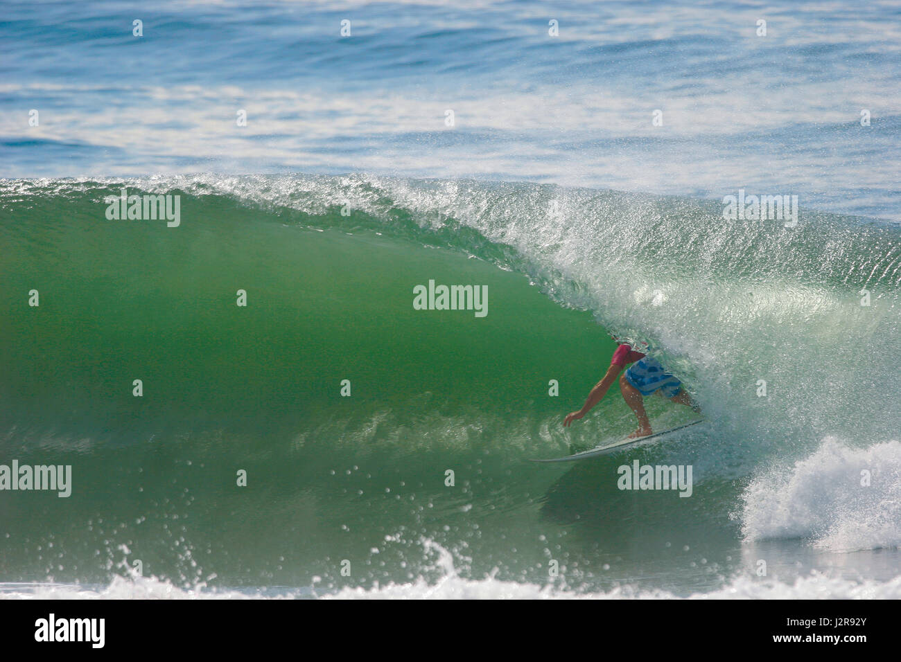 A male surfer rides a tube on a beautiful ocean wave Stock Photo - Alamy