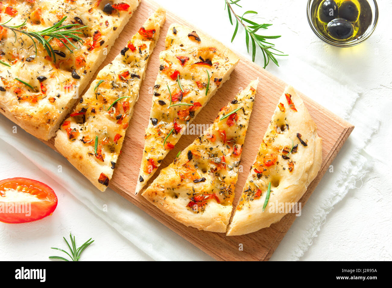 Traditional Italian Focaccia with tomatoes, black olives and rosemary ...