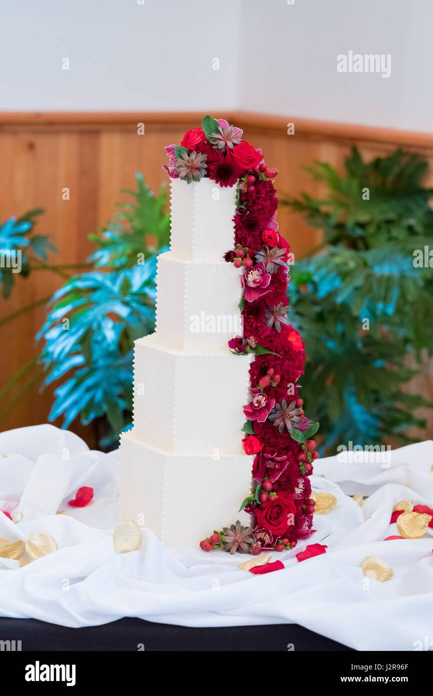 Tower Wedding Cake with Red Flowers Stock Photo - Alamy