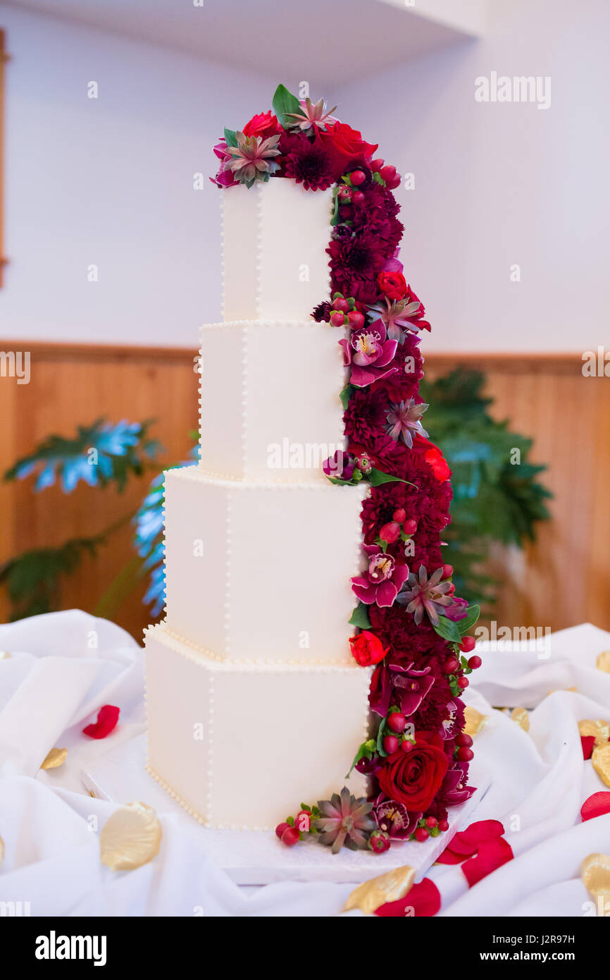 Tower Wedding Cake with Red Flowers Stock Photo - Alamy