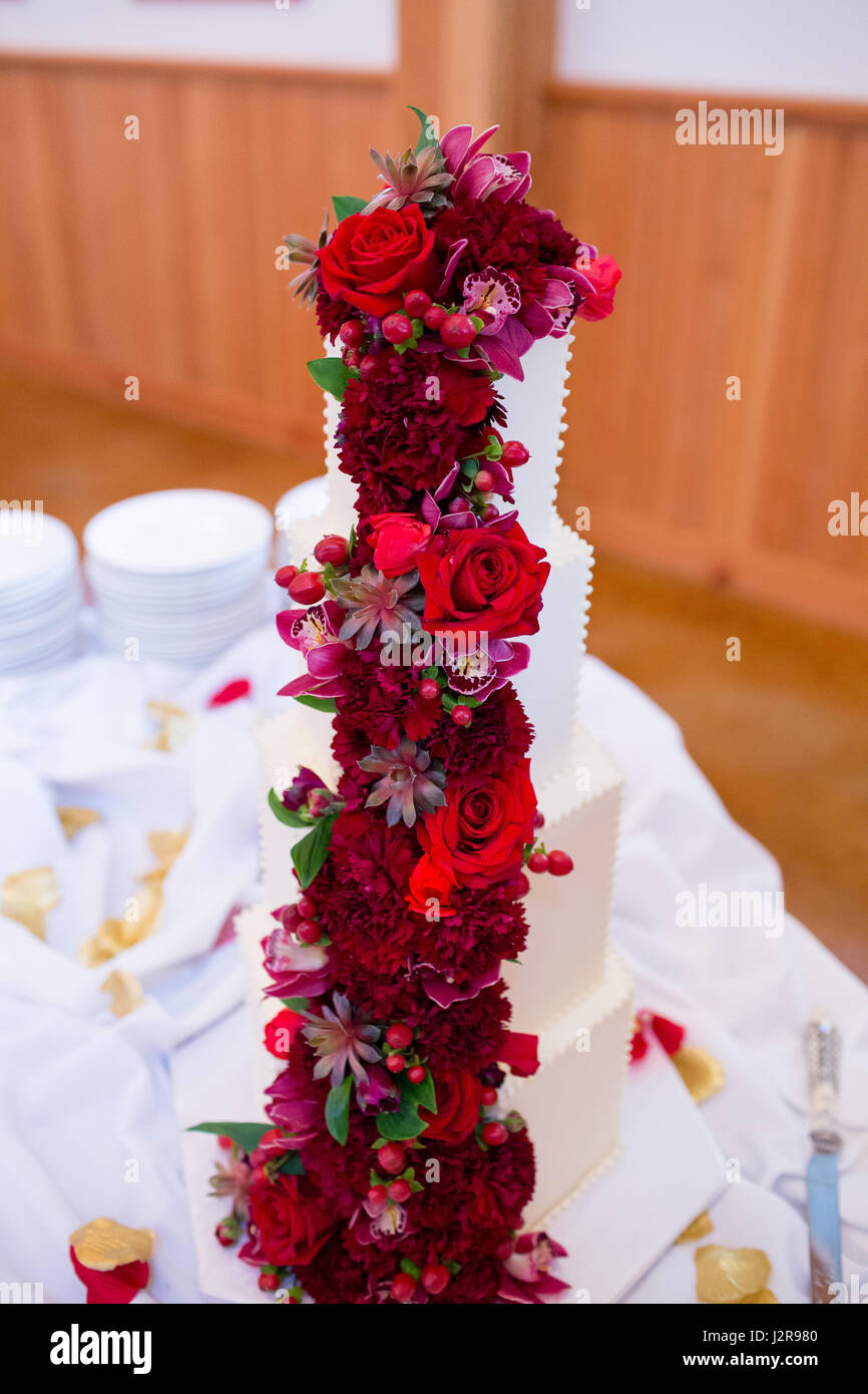 Tower Wedding Cake with Red Flowers Stock Photo - Alamy
