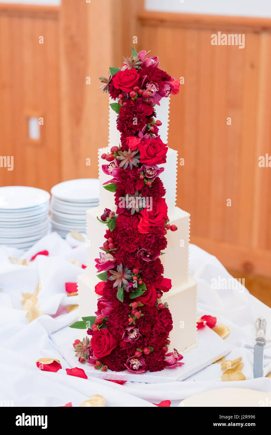 Tower Wedding Cake with Red Flowers Stock Photo - Alamy