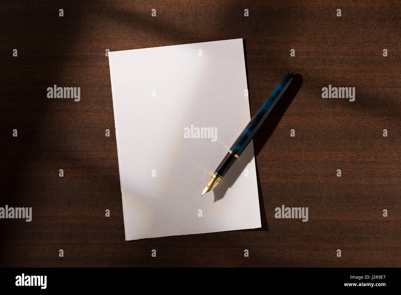 Blank sheet of paper on the table with pen Stock Photo - Alamy