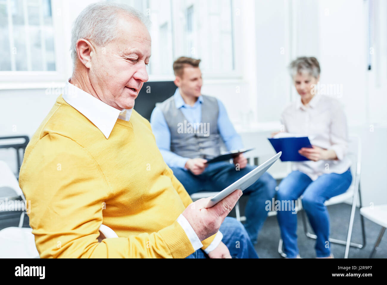 Senior businessman with tablet surfing in the internet Stock Photo - Alamy