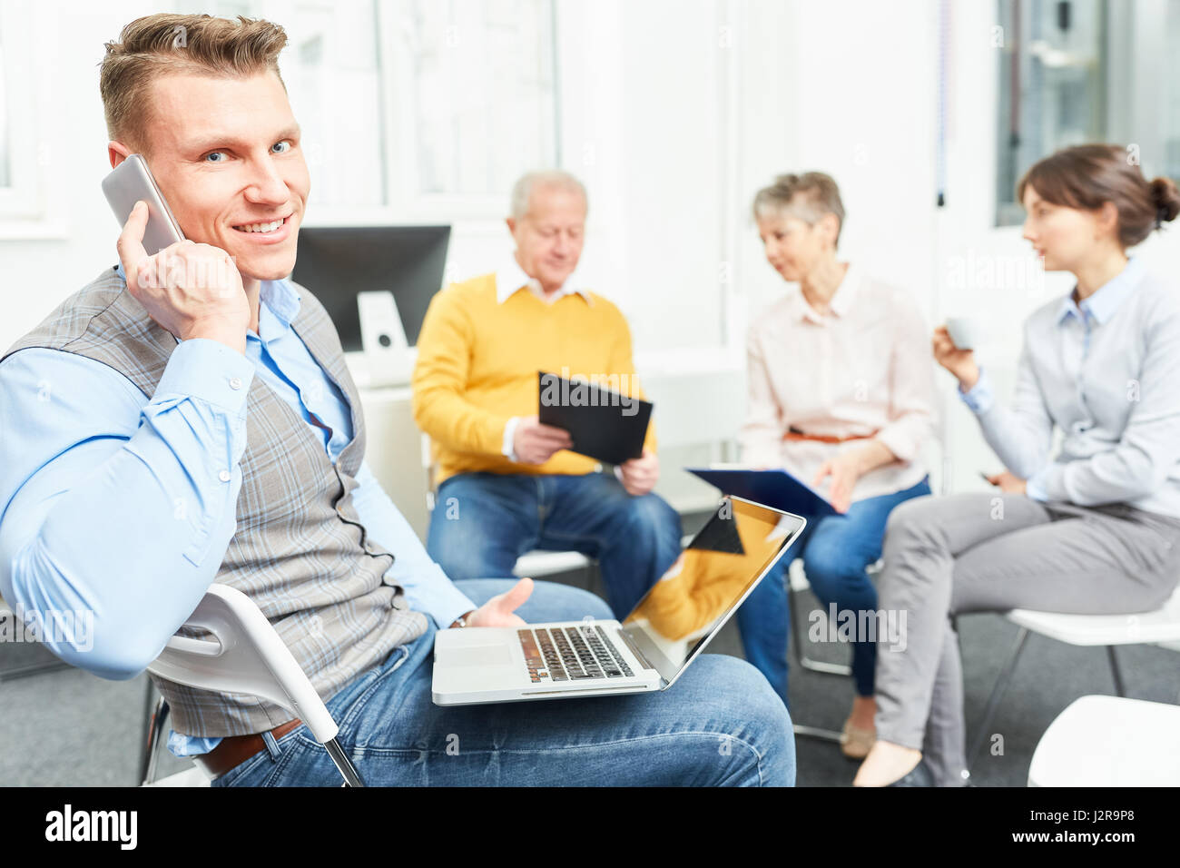 Businessman multitasking while calling with smartphone and holding ...