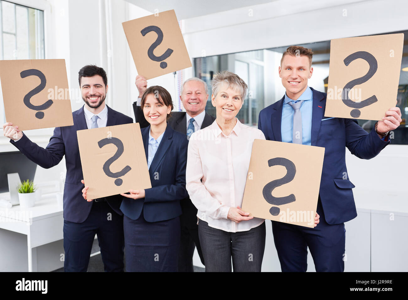 Business team holding question marks in creativity workshop Stock Photo ...