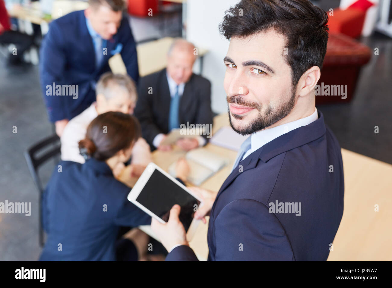 Man as founder manager in start-up business meeting with tablet Stock ...