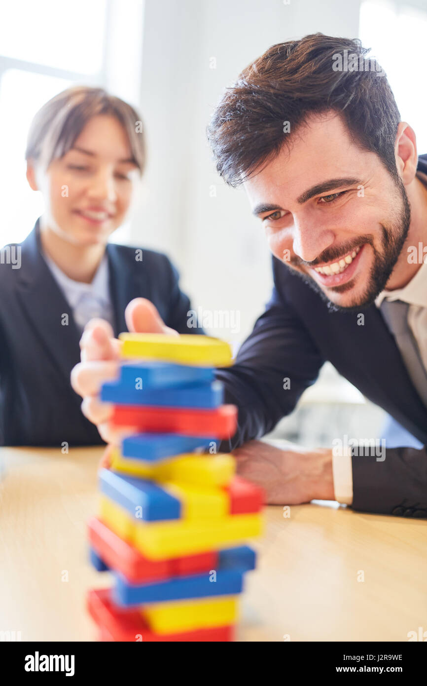 Man bulding blocks as creativity exercise in team building seminar ...