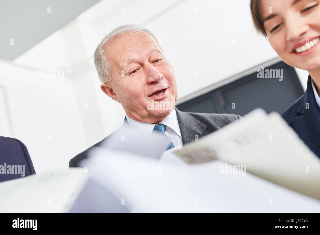 Senior businessman and colleagues make analysis in meeting Stock Photo ...