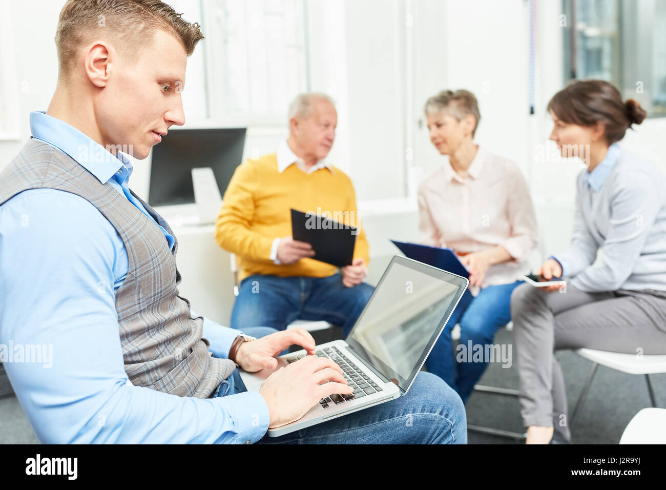Man with laptop computer writes message and researching in the internet ...