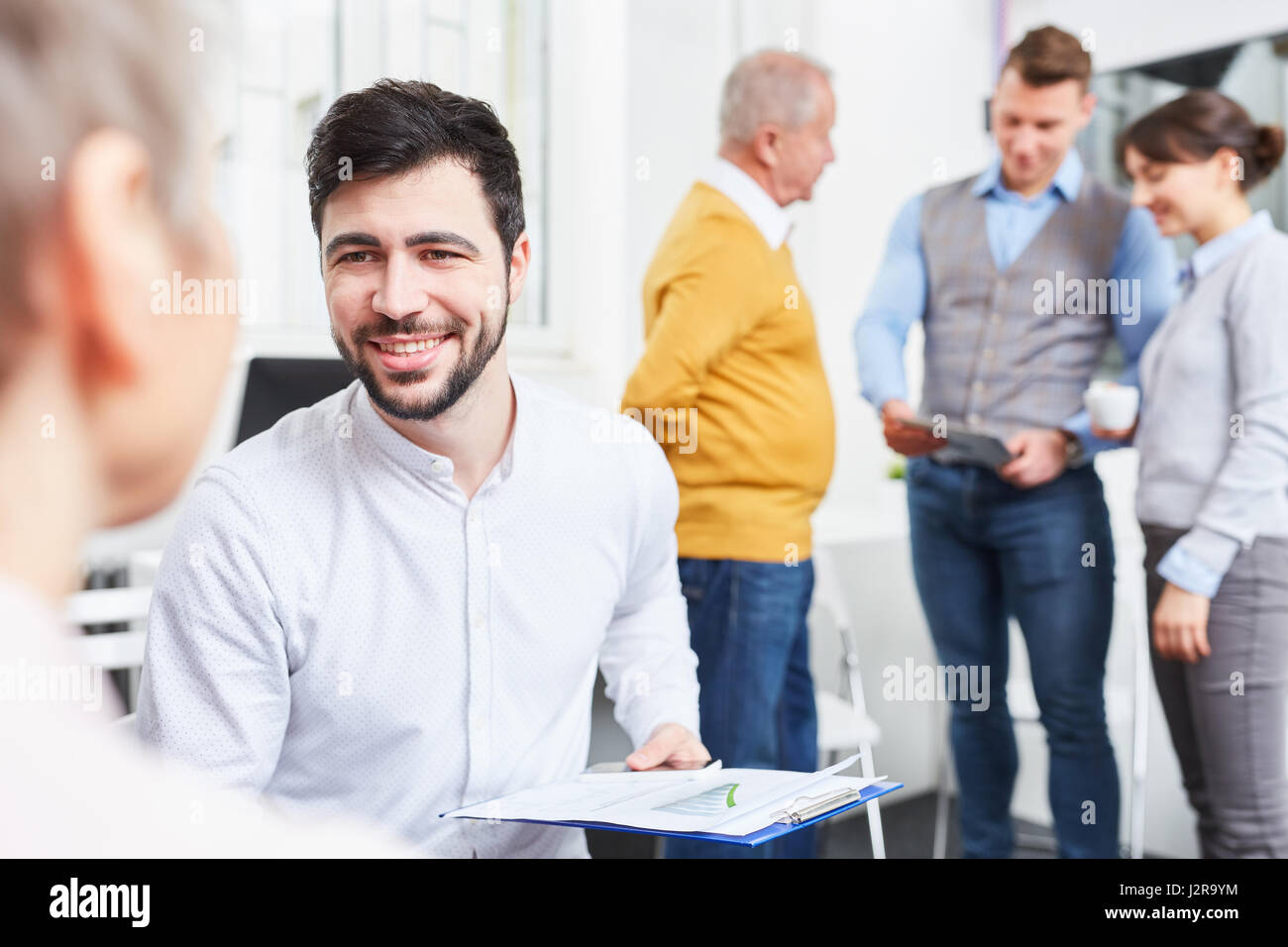 Business people in team meeting with consultant Stock Photo - Alamy
