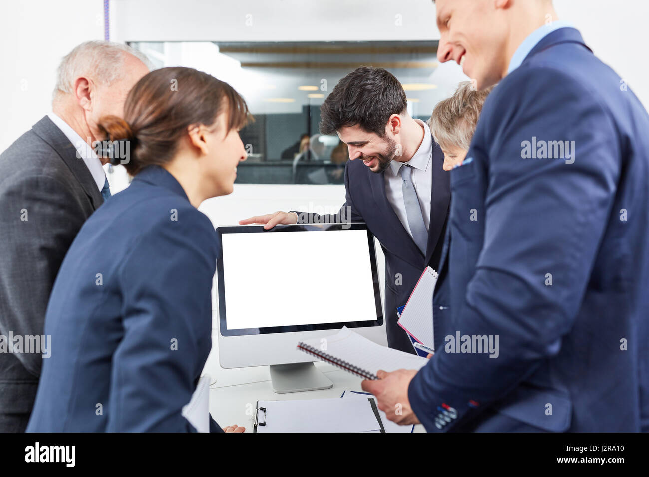 Group of business people stare at blank screen monitor of new computer ...