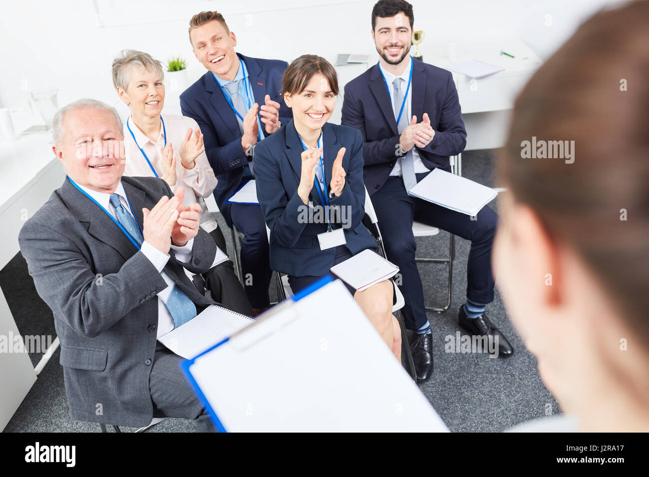Business people give round of applause to seminar speaker Stock Photo ...