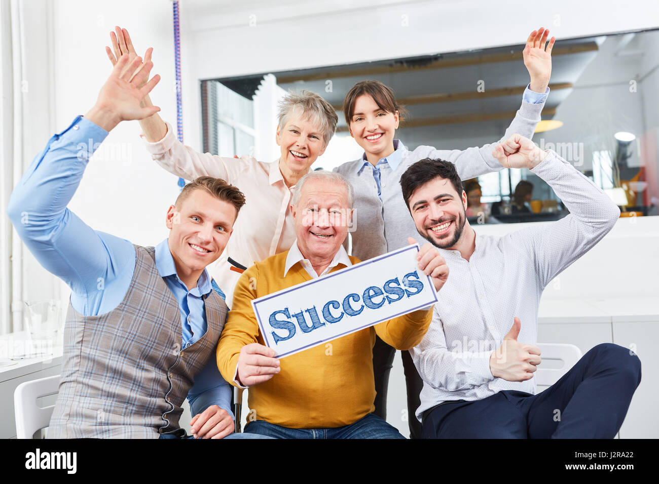 Business team holds sign that reads success as winner and teamwork ...