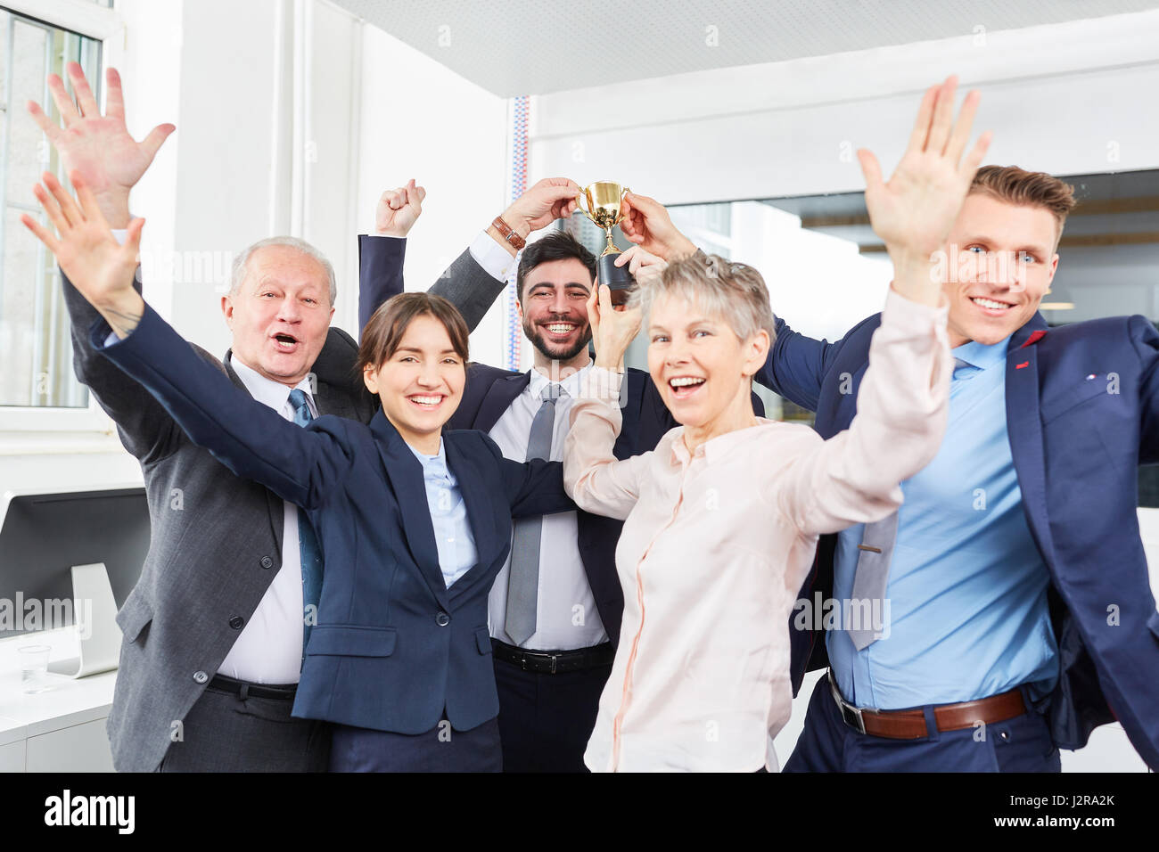 Business successful team cheering as a group with winner trophy Stock ...