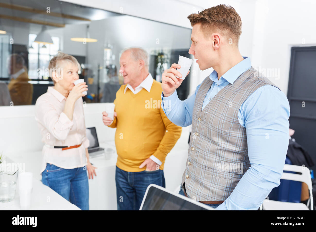 Business people in relaxation drink water in their break Stock Photo ...