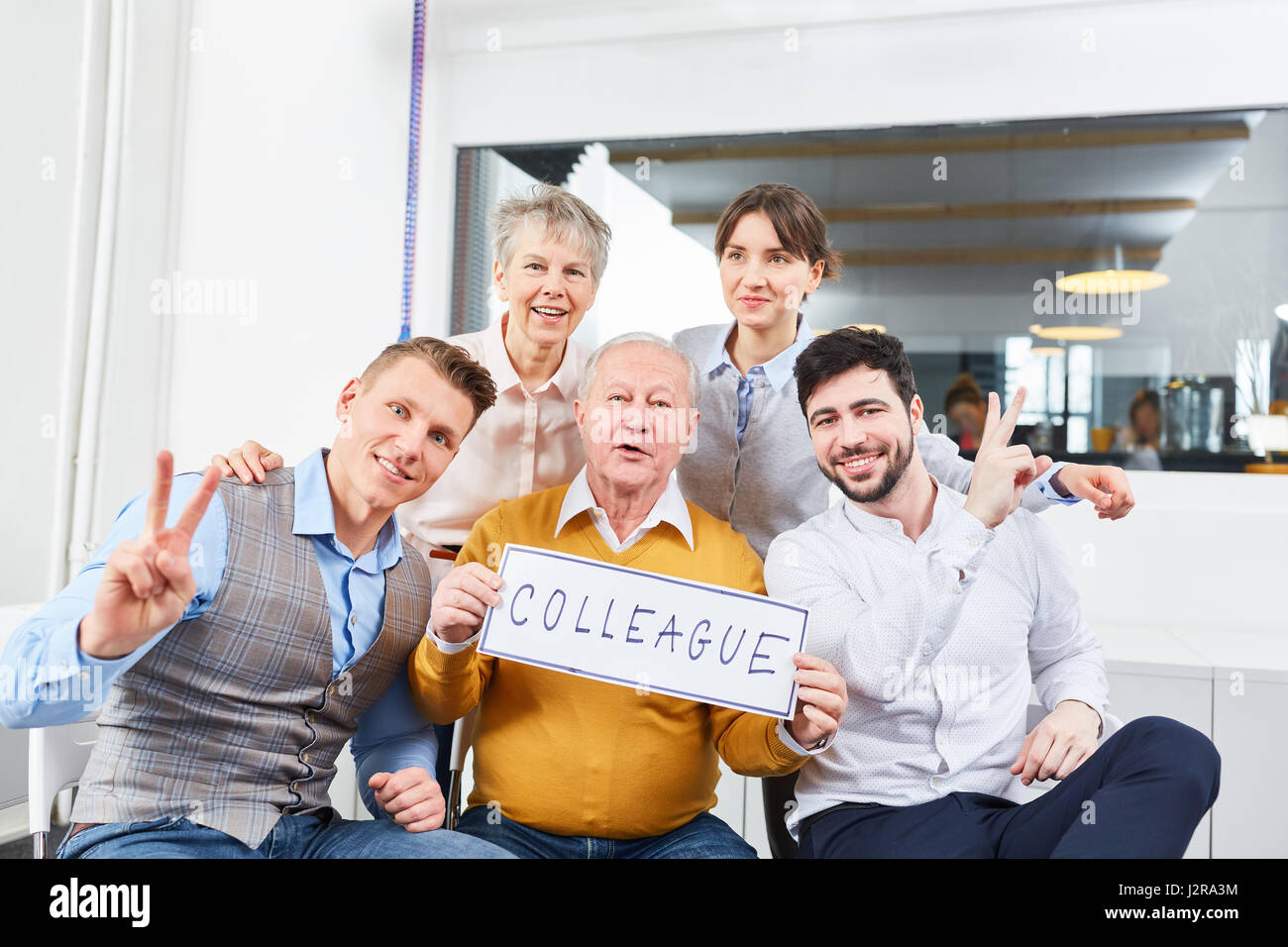 Business team of colleagues with sign that reads colleague Stock Photo ...