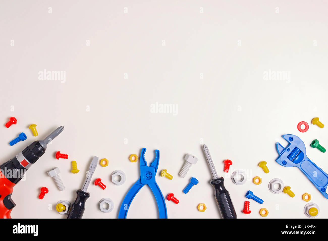 Toys construction tools border on white background. Top view. Flat lay ...