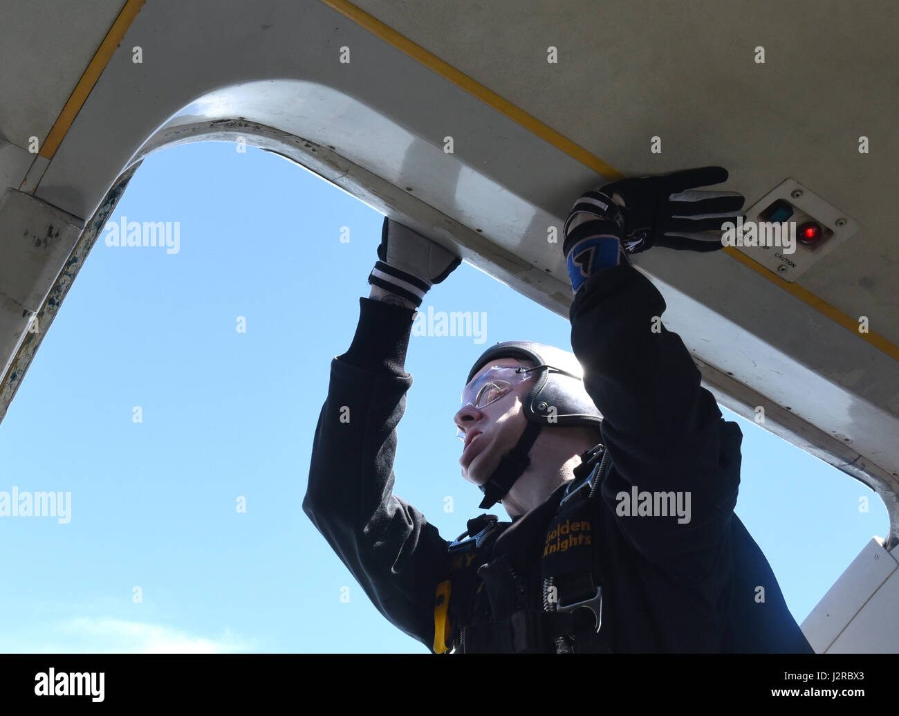 A U.S. Army Golden Knights skydive team member puts his face in the ...