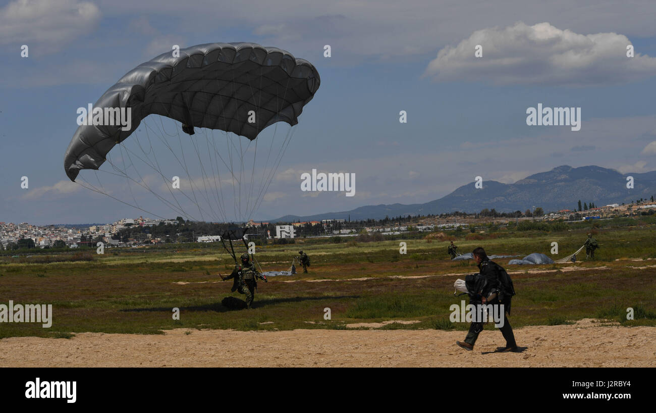 A Greek paratrooper lands at the drop zone after jumping from a U.S ...
