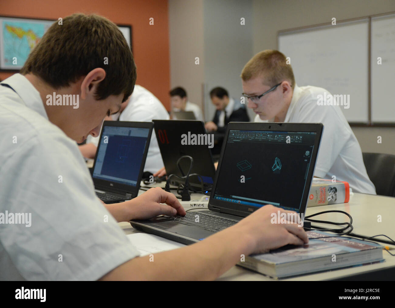 High school students build a mechanical design during a competition at ...