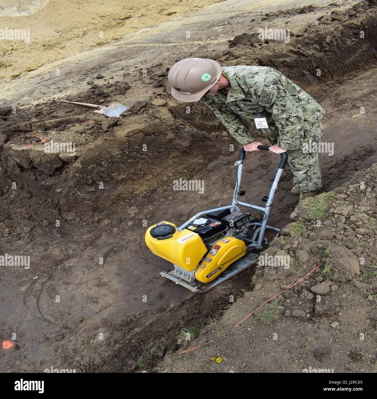 Builder from Naval Mobile Construction Battalion tamp dirt for ...