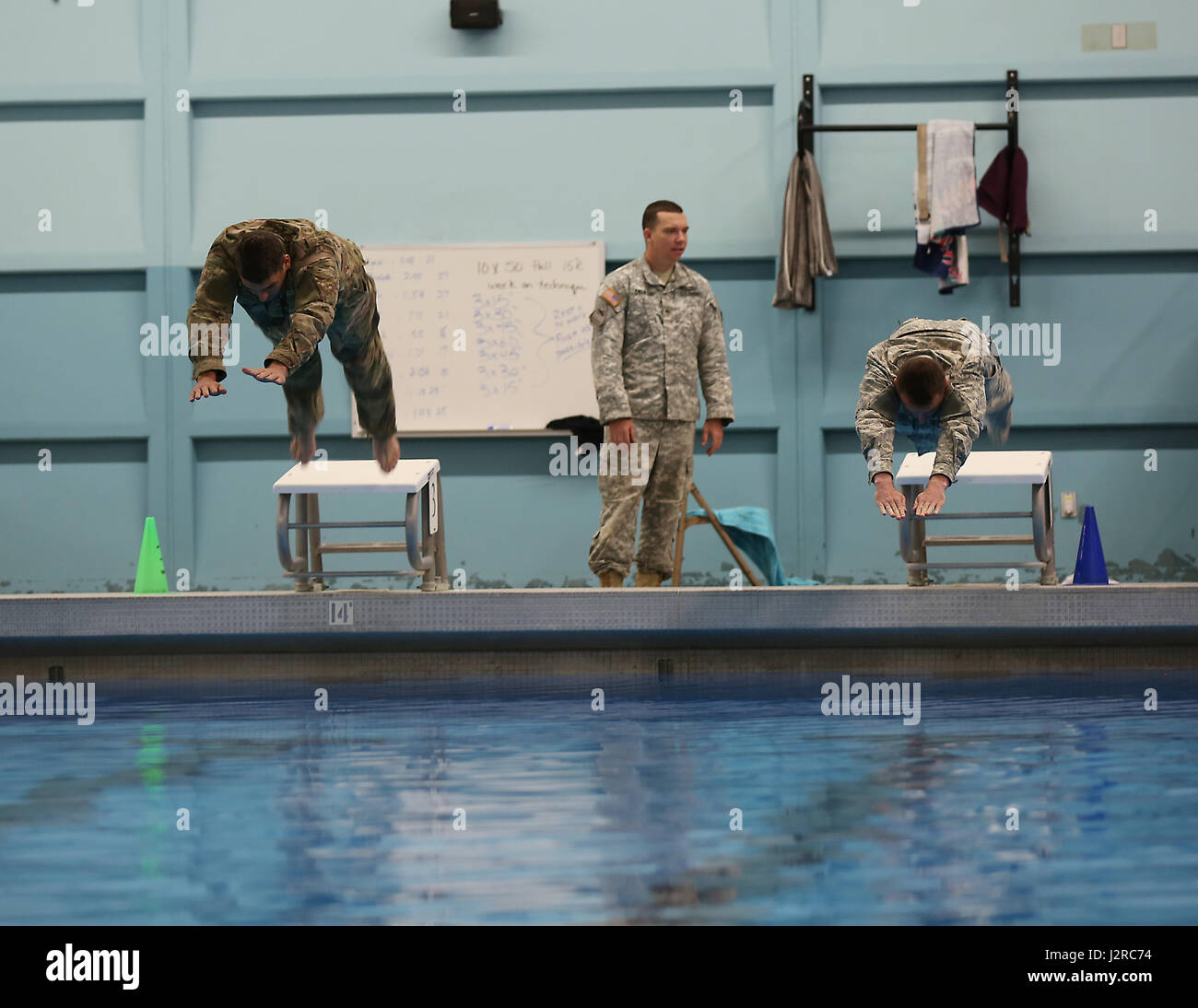 U.S. Soldiers with the 20th CBRNE Command, dive into the pool to ...