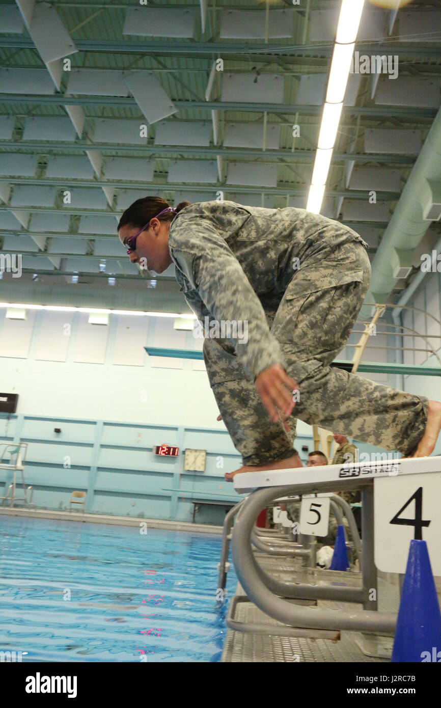 A U.S. Soldier with the 20th CBRNE Command, dives into the pool to ...