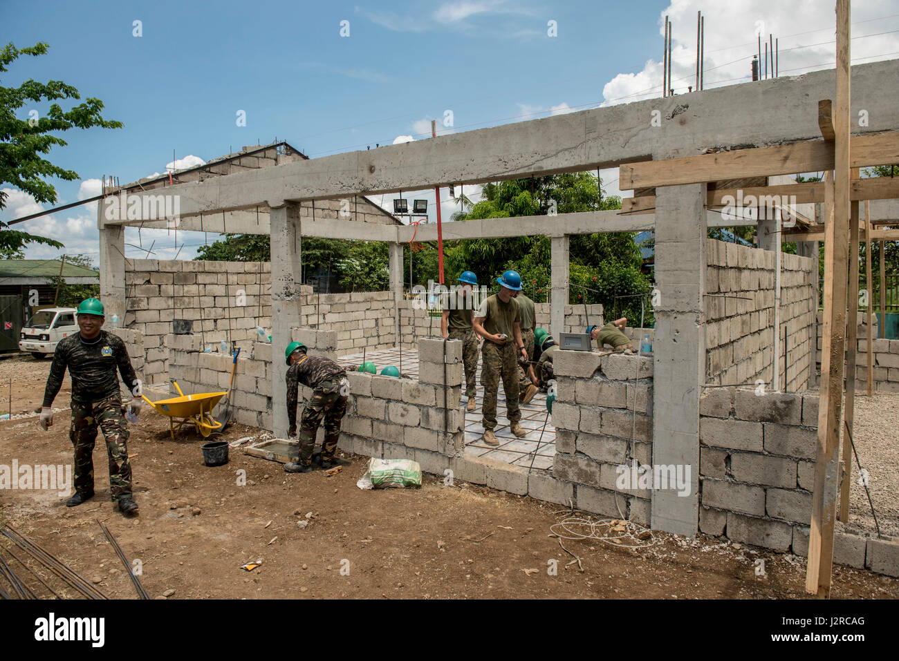 Philippine soldiers and U.S. military engineers prepare a structure for ...