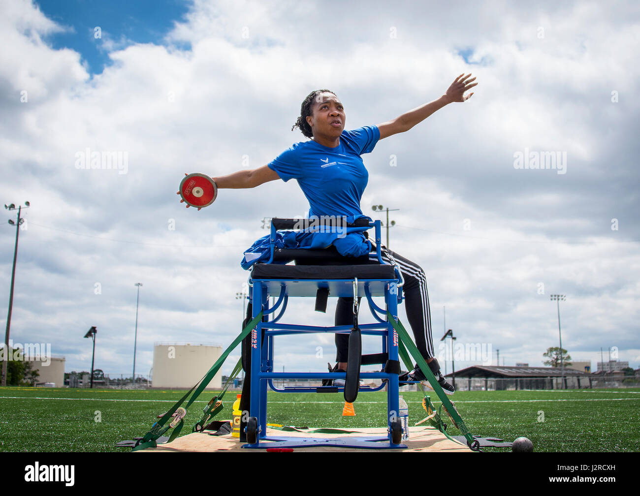 A Warrior CARE athlete winds up to throw the discus at a track and ...