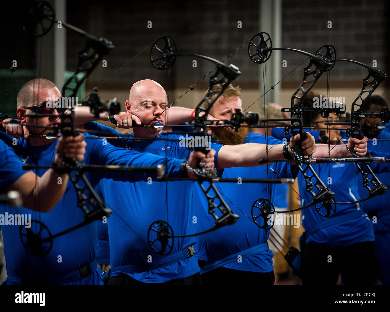 Mark Blinn, a Warrior CARE athlete, aims for a bullseye with his other ...