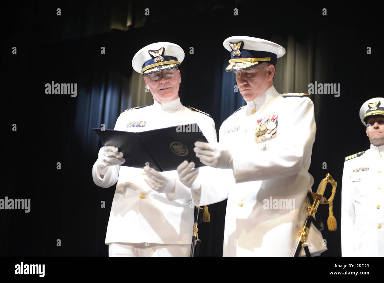 Rear Adm. Dave Callahan presents Captain Martin with his certificate of ...