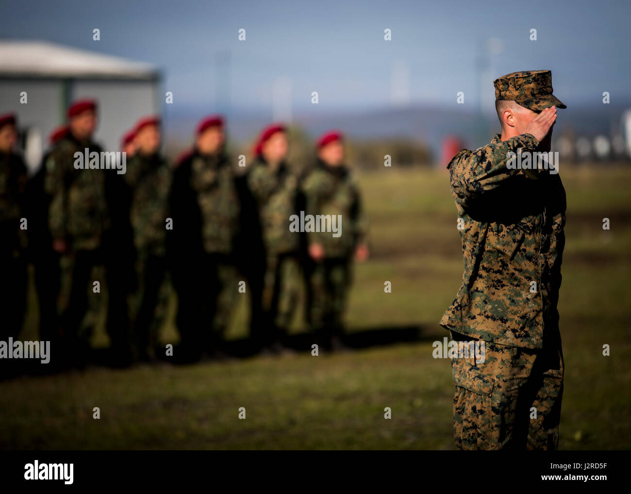 U.S. Marine 1st Lt. Ian Lynch, commander of troops, salutes during the ...